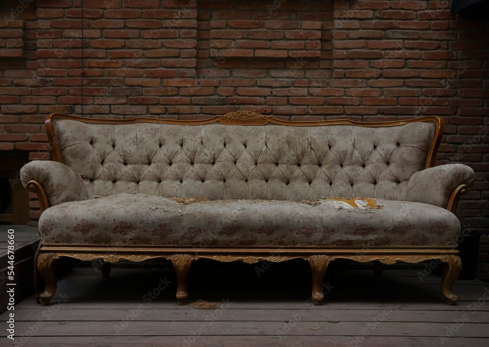 very old ripped couch. An old broken brown sofa needs repair. Large ...