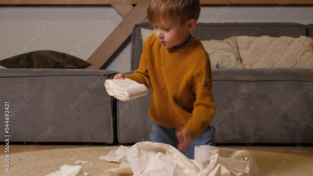 Small child has made a mess, scattered toilet paper around the ...
