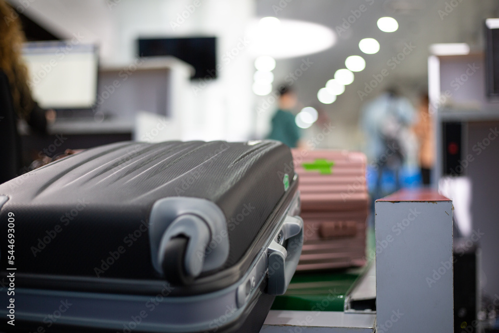 Luggage on conveyor belt at the airline counter service at the airport ...