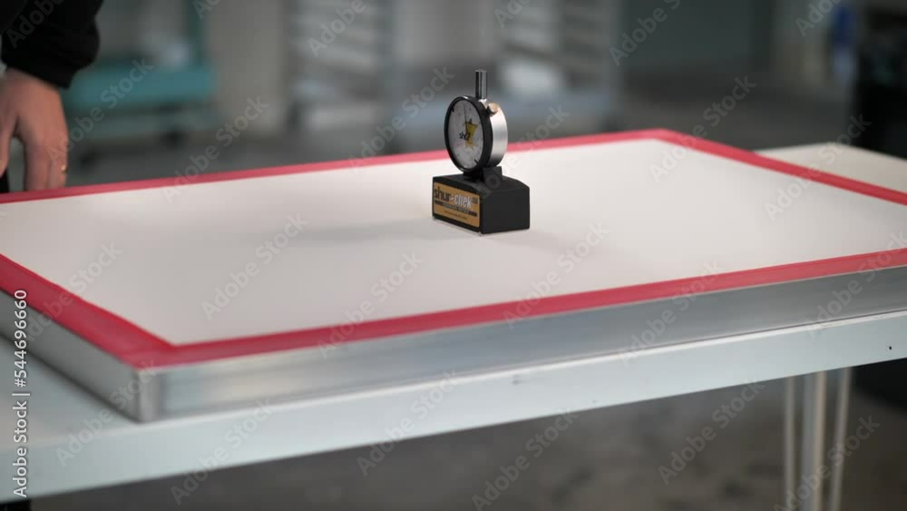 Measuring tension of screen printing screens with a newton meter to ...