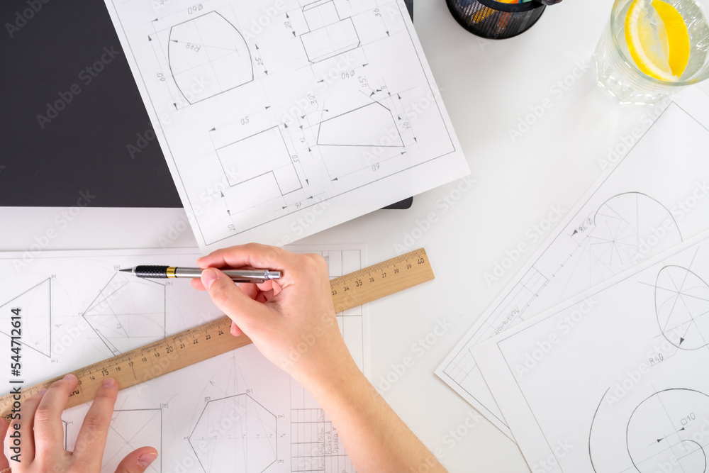 A young woman does her mechanical drawing homework. Mechanical drawing ...