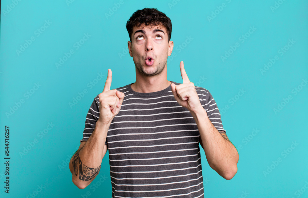 feeling awed and open mouthed pointing upwards with a shocked and ...