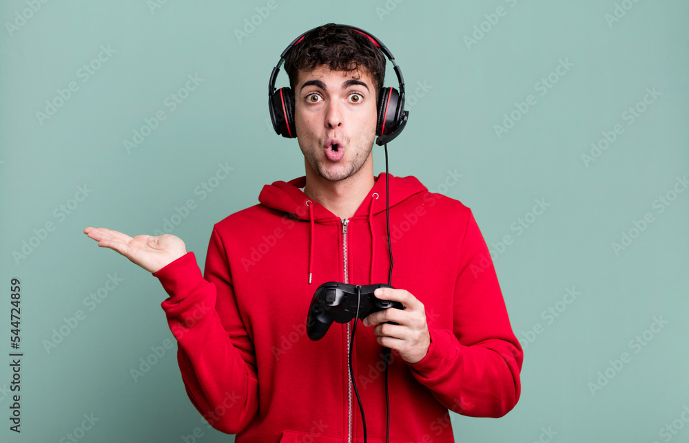 adult man looking surprised and shocked, with jaw dropped holding an ...