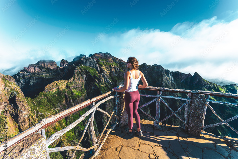 Woman enjoying the mountain scenery of Pico Ruivo from a viewing ...