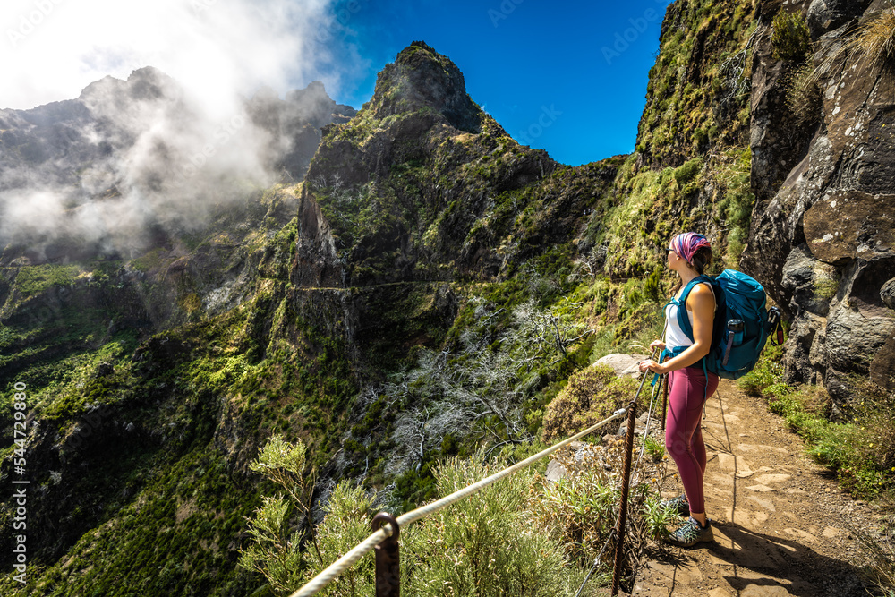 Hiker with backpack enjoying the view along very scenic hike trail to ...