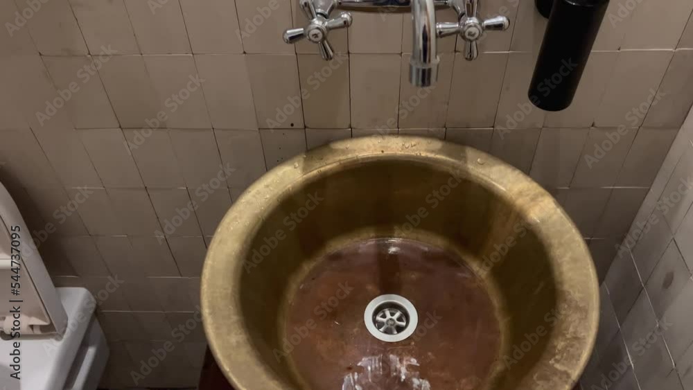 Bronze basin for washing hands in the toilet. An antique copper bowl ...