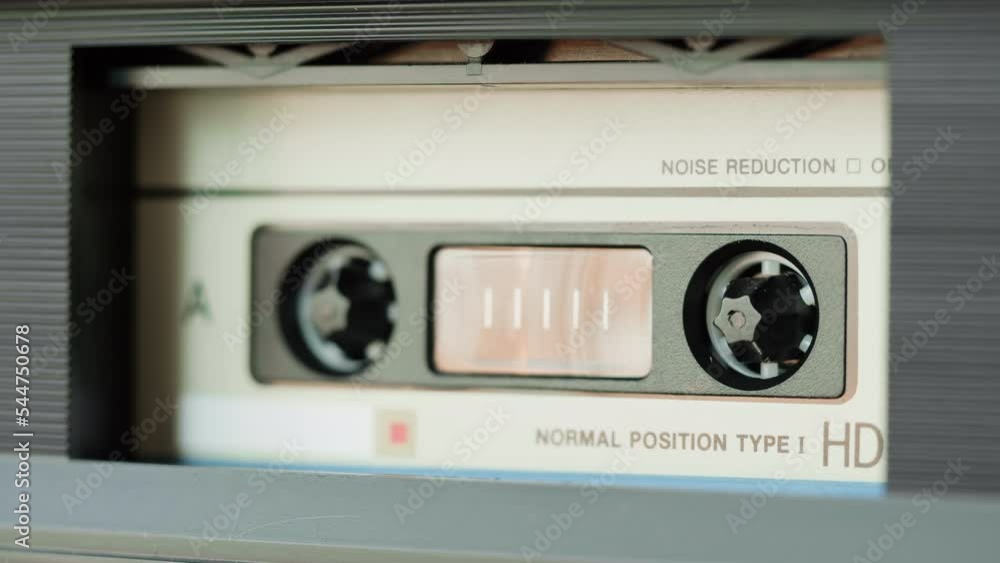 Retro radio tape recorder, audio cassette playing close-up. Listening ...