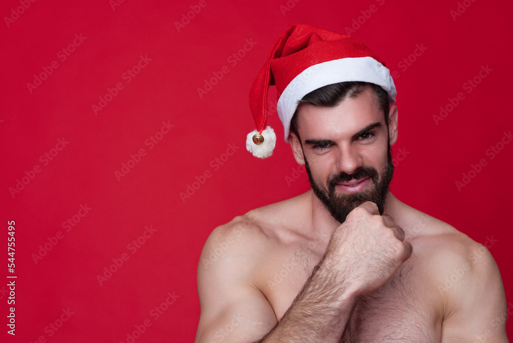 Sexy santa, young shirtless bodybuilder wearing a christmas hat ...