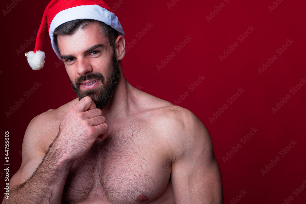Sexy santa, young shirtless bodybuilder wearing a christmas hat ...