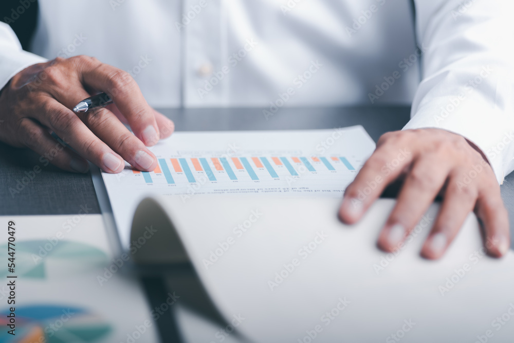 Business people read business statistics chart reports, to analyze and ...