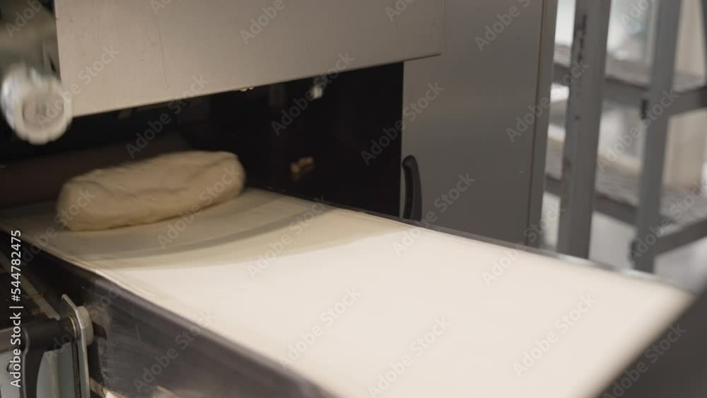 The work of the dough divider in the bakery. The dough after division ...