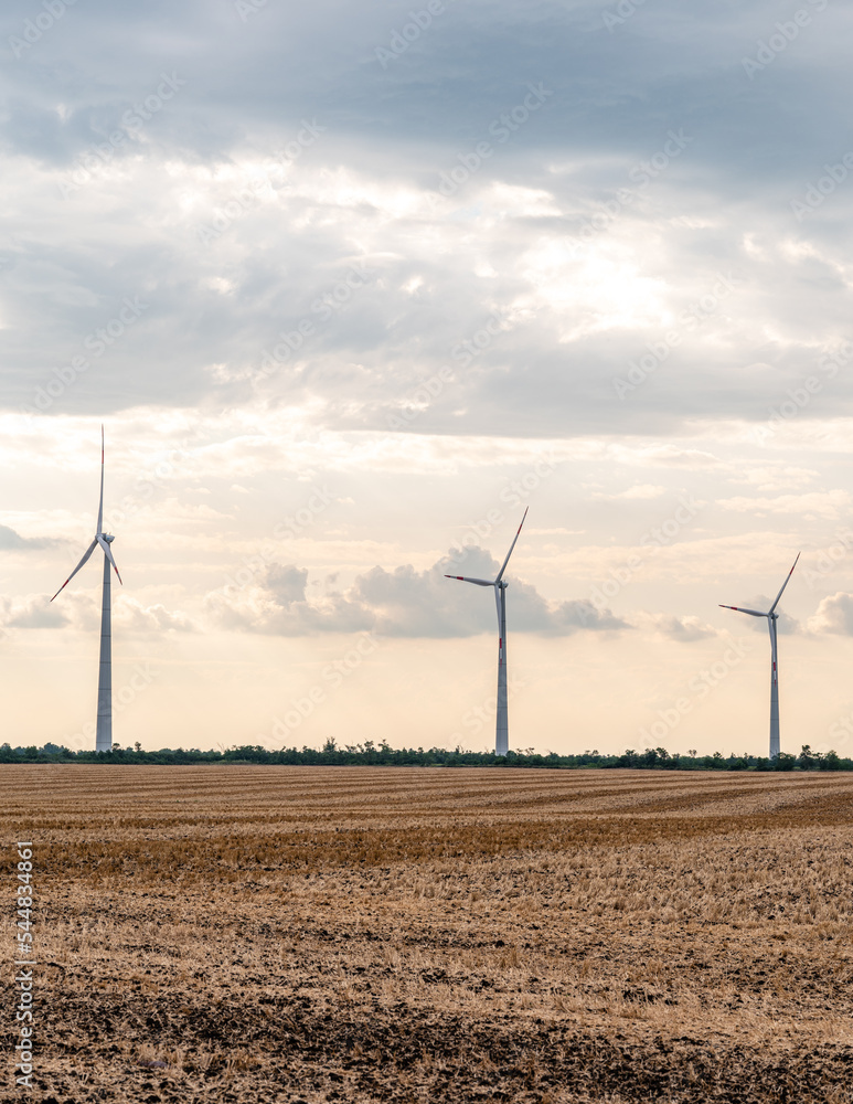 Adyghe wind farm from many towers of wind turbines in field. Towers of ...