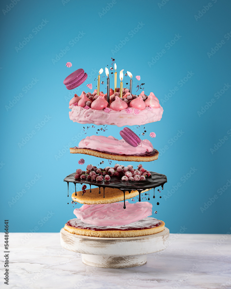 Flying cake layers with berries,chocolate,macarons,pink cream,festive ...