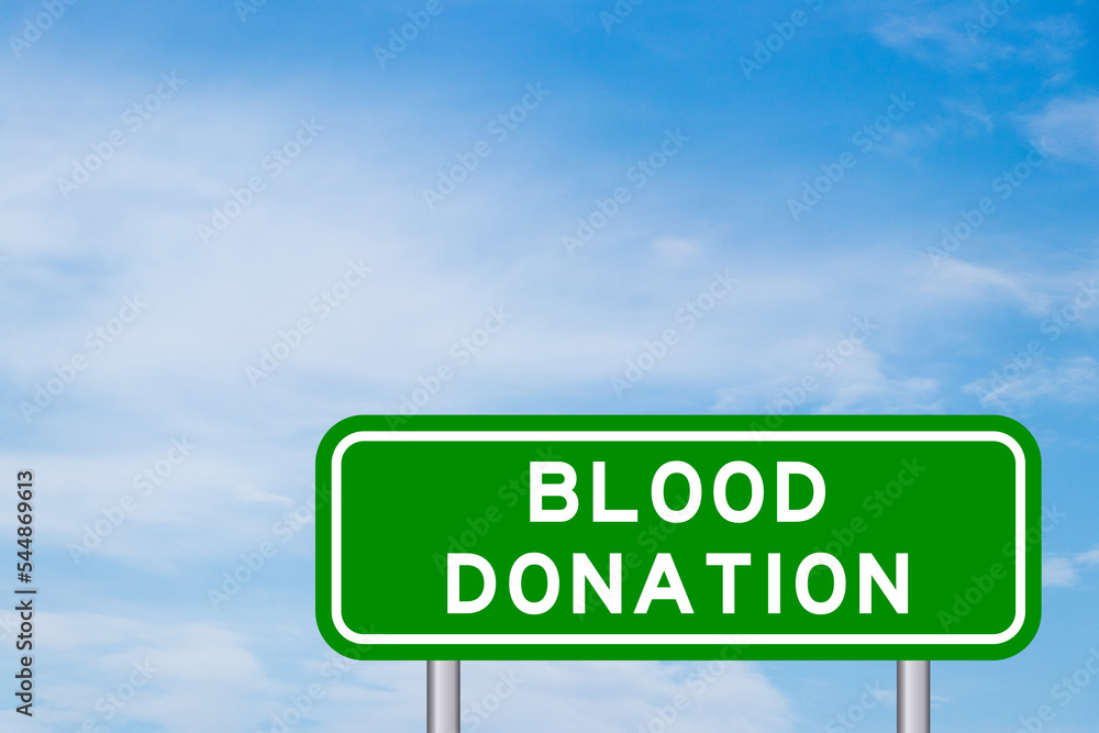 Green color transportation sign with word blood donation on blue sky ...