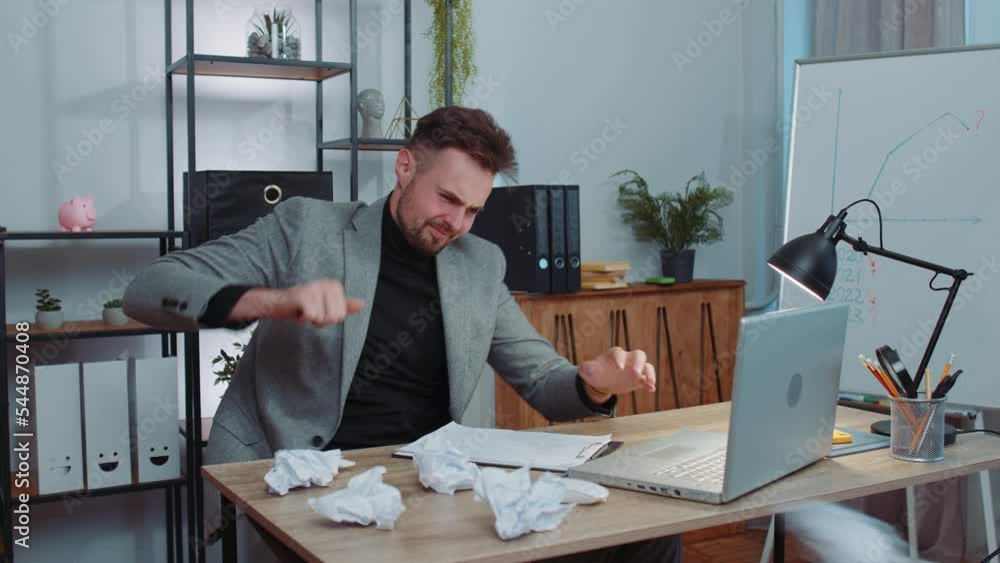 Angry furious man working at home office throwing crumpled paper ...
