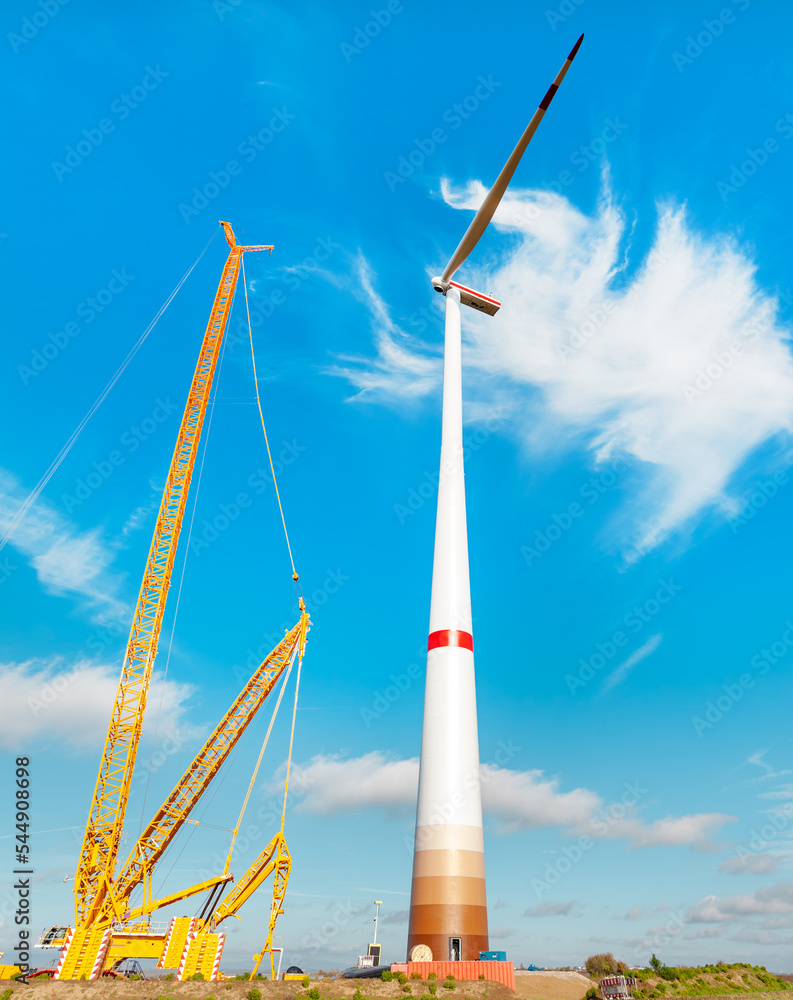Construction work. Large wind power station nacelle on tower high up ...