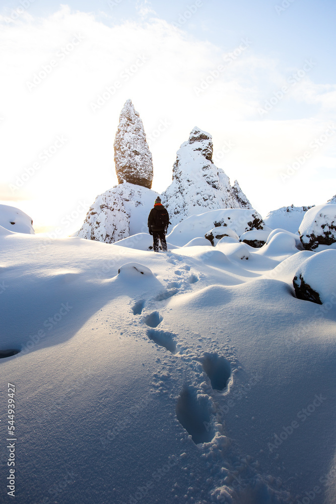 Old Man of Storr in the snow, Isle Of Skye. Person hiking in snow up ...