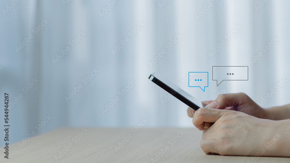 Hand using smartphone typing Live chat chatting and social network ...