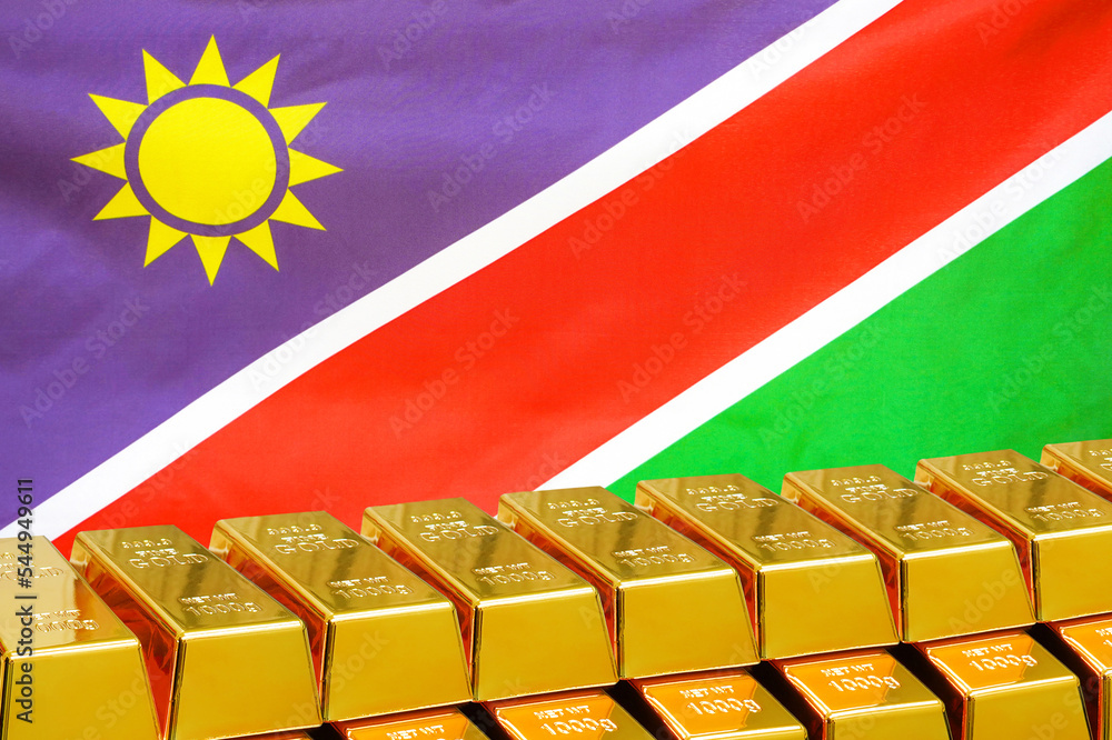 Row of shining golden bullions on the Namibia flag background. Business ...