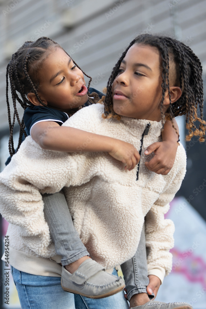 Portrait of boy giving piggyback ride to younger brother Stock Photo ...