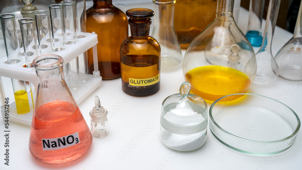 Food additives in test tubes and flasks on the laboratory table. food ...