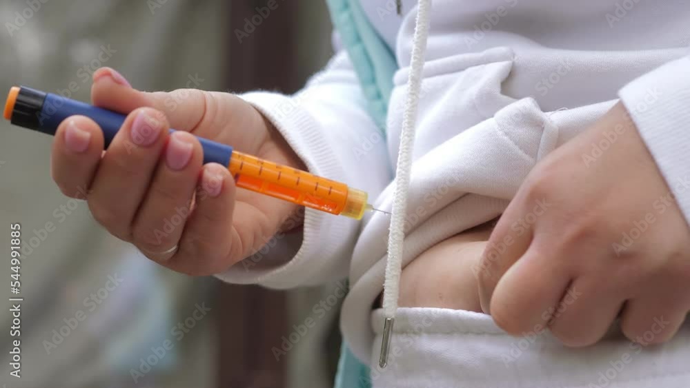 Woman diabetic using insulin pen for injecting insulin at home ...