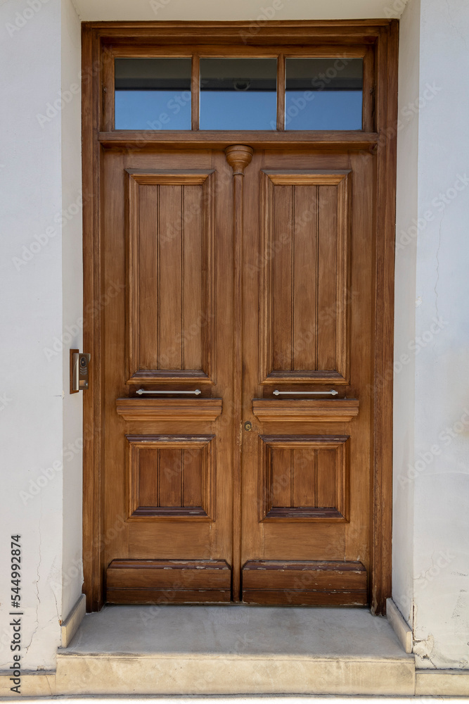 Stylish wooden front door with glass window above in white stone ...