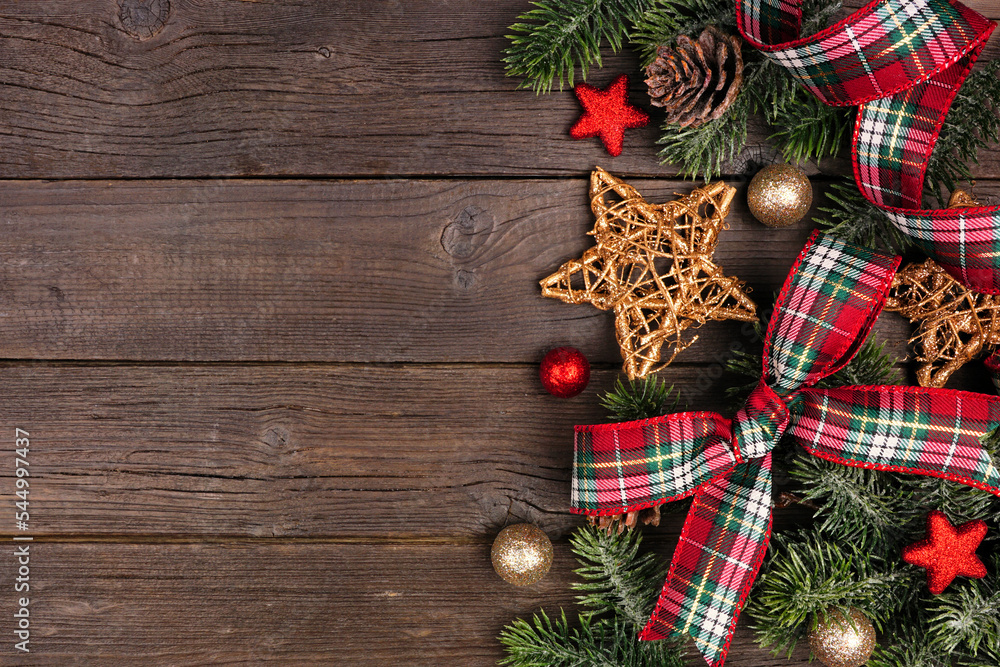 Christmas side border of ornaments, branches and red and green plaid ...