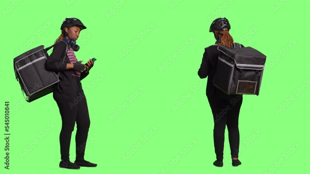 Female courier using smartphone online and delivering food order in ...