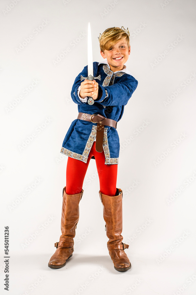 Child youth boy dressed as a cosplay prince holding his sword and ...