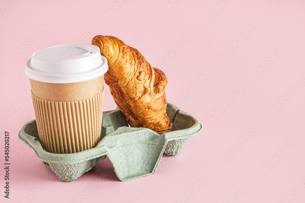 Holder with paper cup and tasty croissant on pink background Stock ...