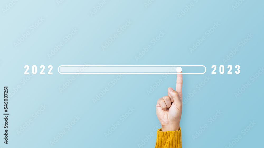 Man hand touching loading bar for countdown to 2023. Loading year 2022 ...