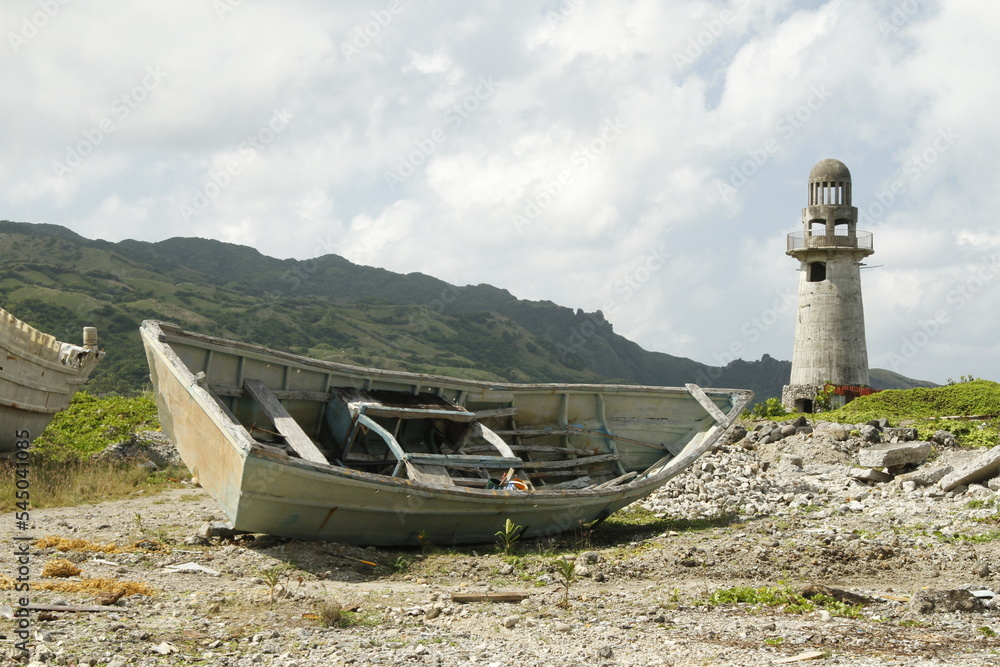 Abandoned fishing boat and lighthouse at Batan Island, Batanes ...