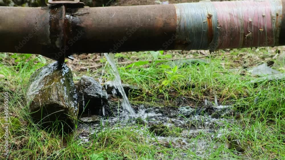 Water flowing from cracked pipe. Municipal accident, water leakage due ...