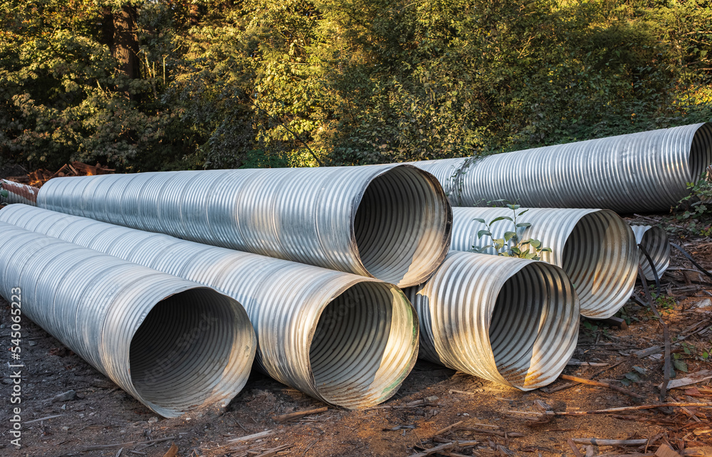 Stormwater pipes. Large Corrugated Metal Culvert Pipes in Field ...