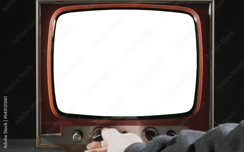 The hand of a man turning on and off a retro vintage tv set, with an ...