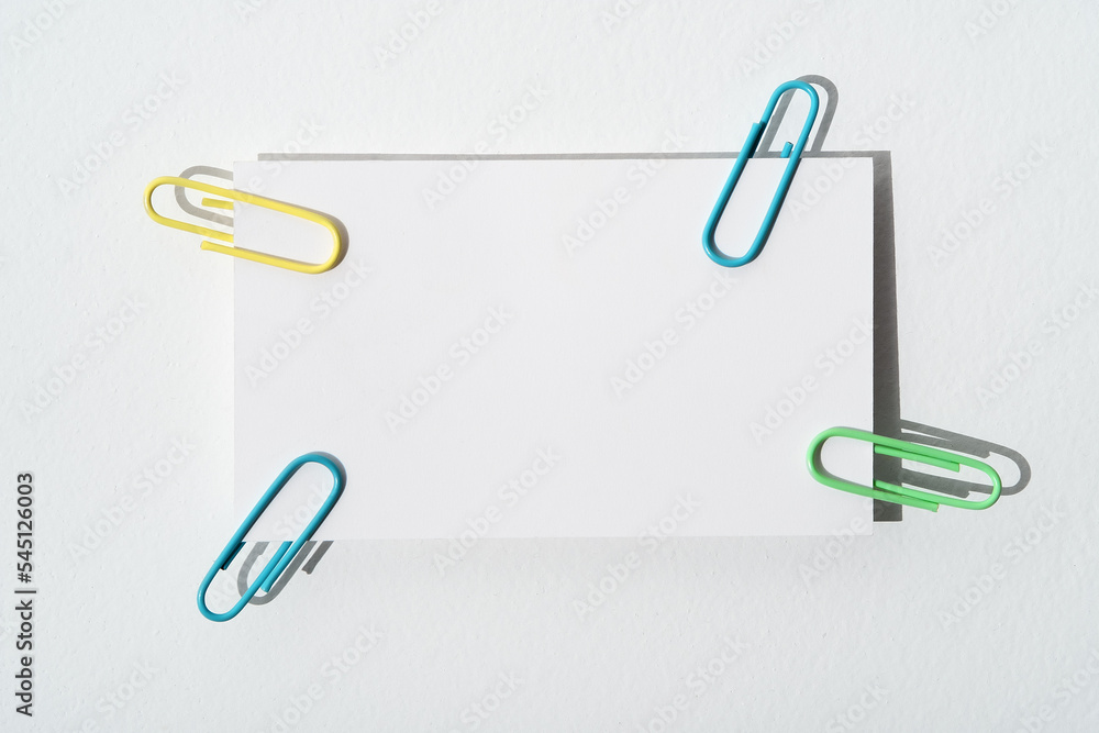 Close-up white sheet with copy space attached paper clips. Business ...