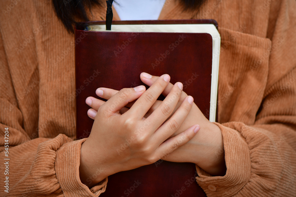 young woman hugging bible and praying to god. Christian Concepts. Stock ...
