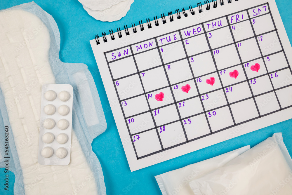 Top view photo of sanitary pads, ladies calendar with marks on isolated ...