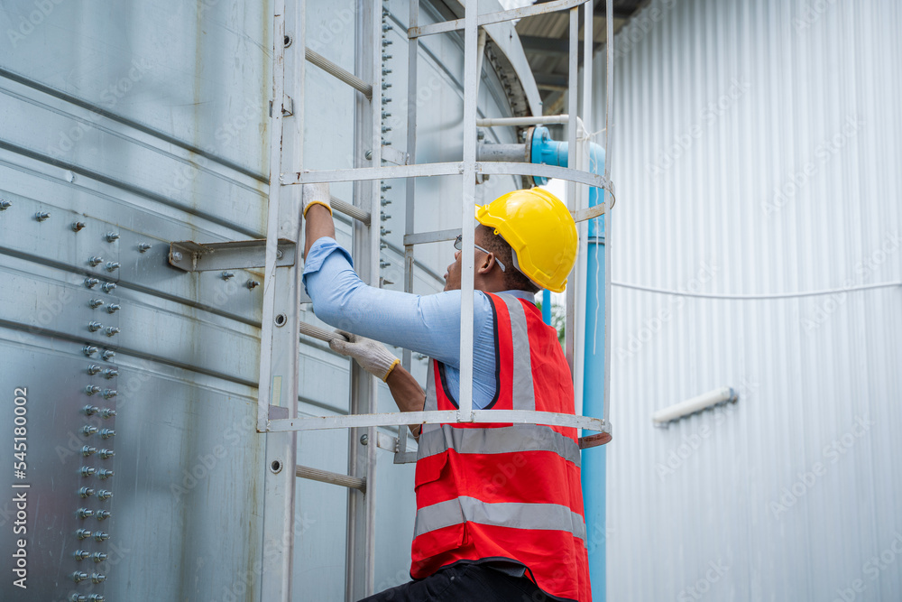 Construction worker wearing safety harness and safety line working at ...