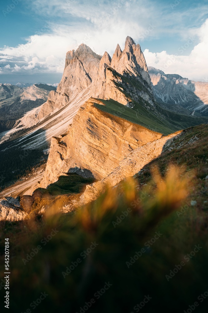 Vertical shot of the rocky Seceda mountain in Italy with the sunlight ...
