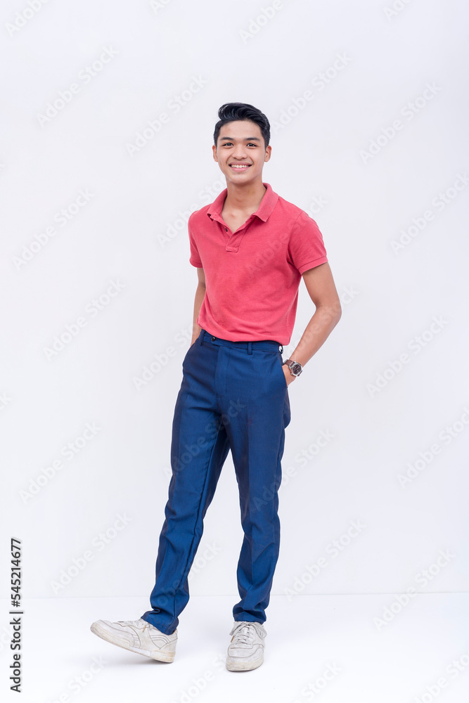 A tall and handsome filipino man in a red polo shirt and blue jeans ...