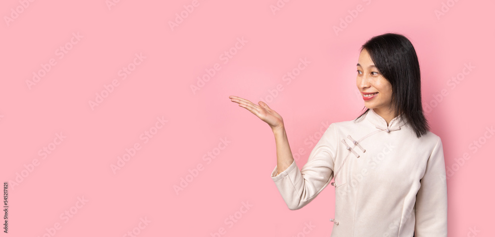 showing Happy smiling Chinese woman in traditional dress on a pink ...