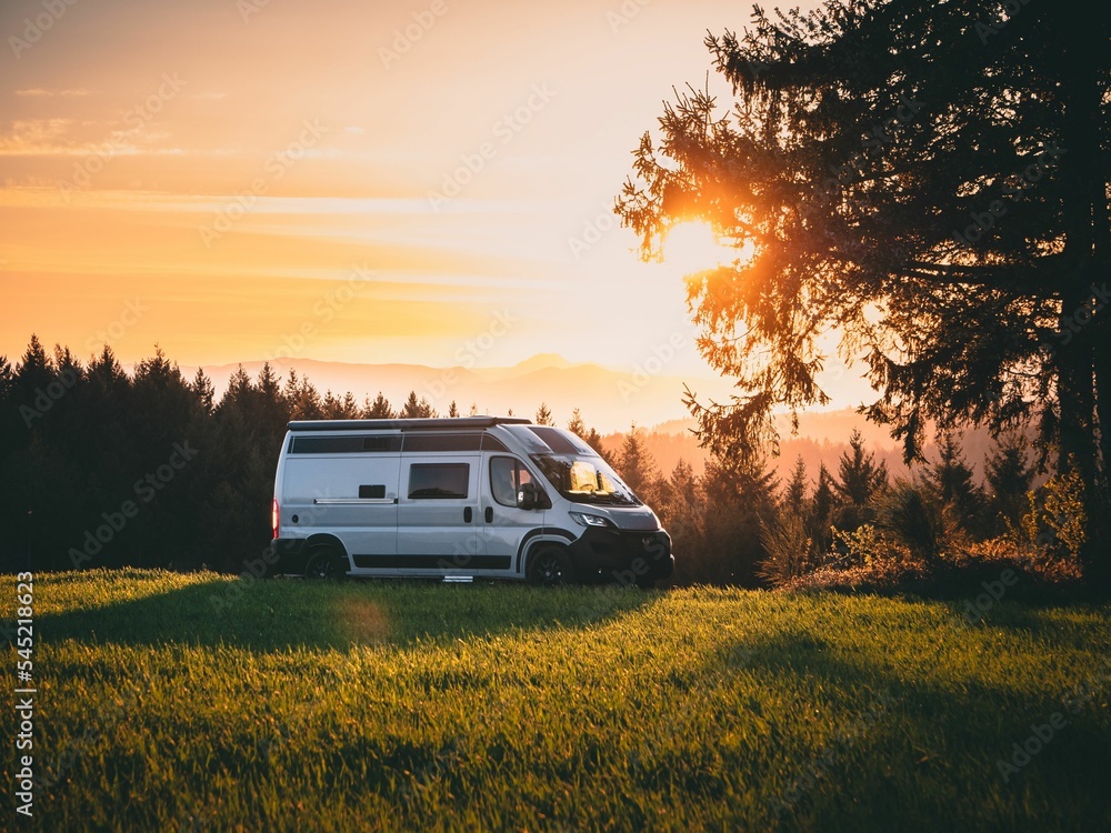 Dazzling sunset view with a campervan parked in the Black Forest ...