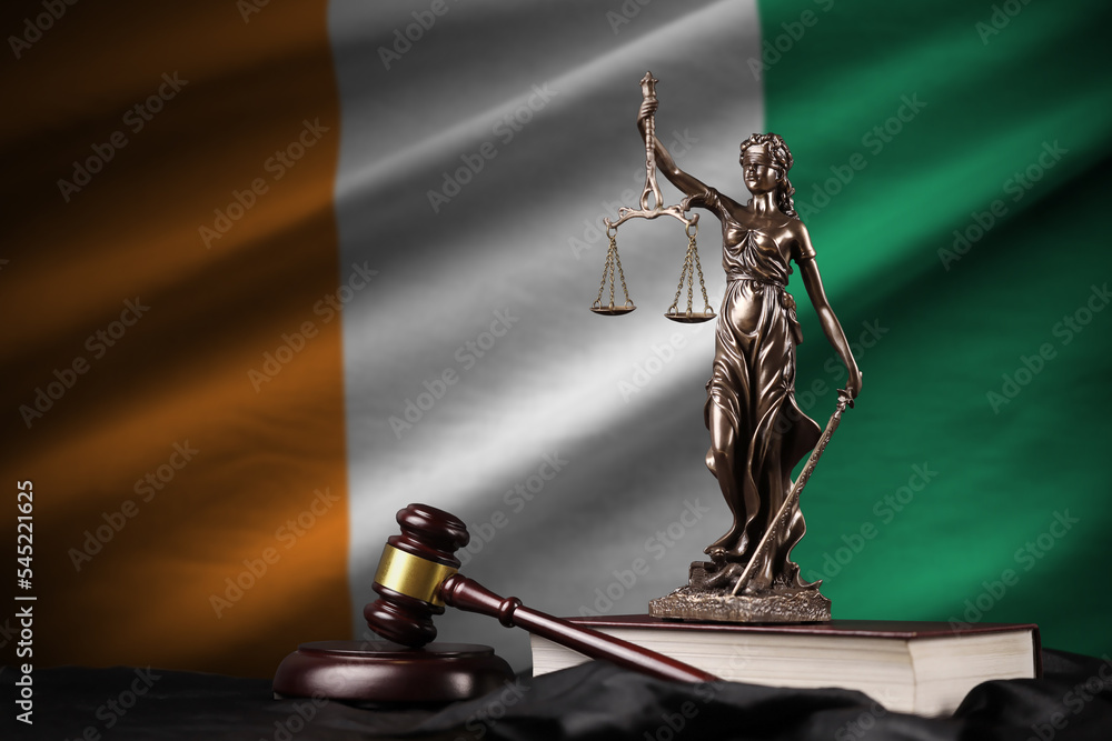 Ivory Coast flag with statue of lady justice, constitution and judge ...