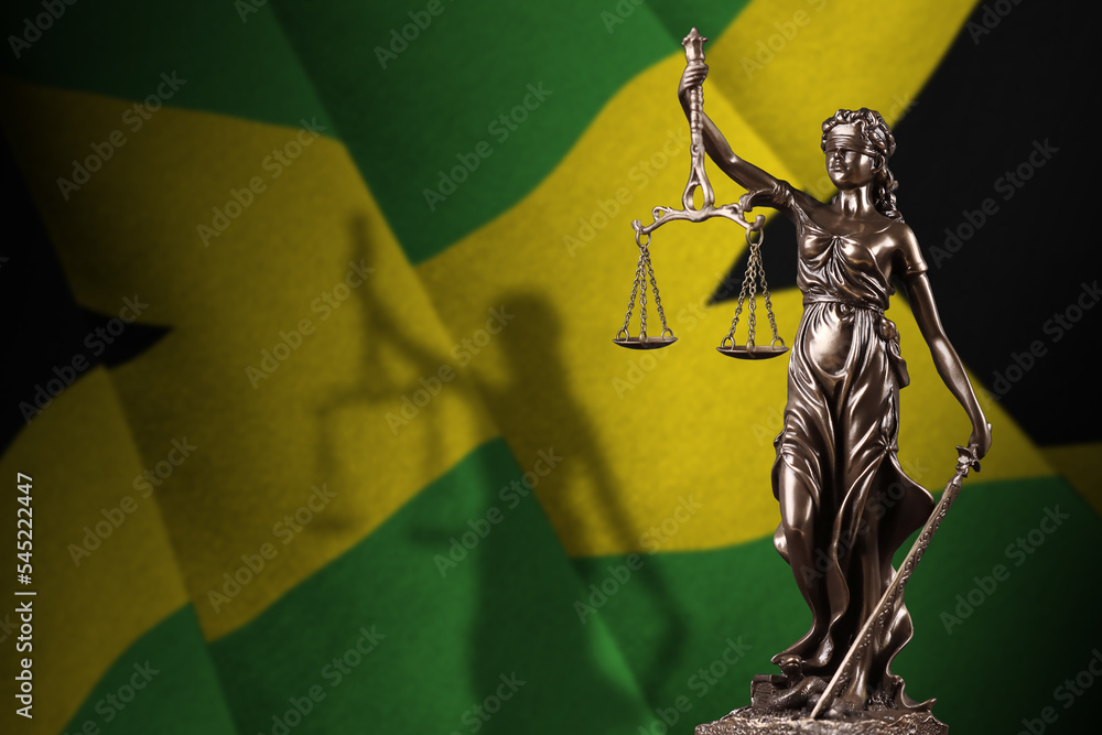 Jamaica flag with statue of lady justice and judicial scales in dark ...