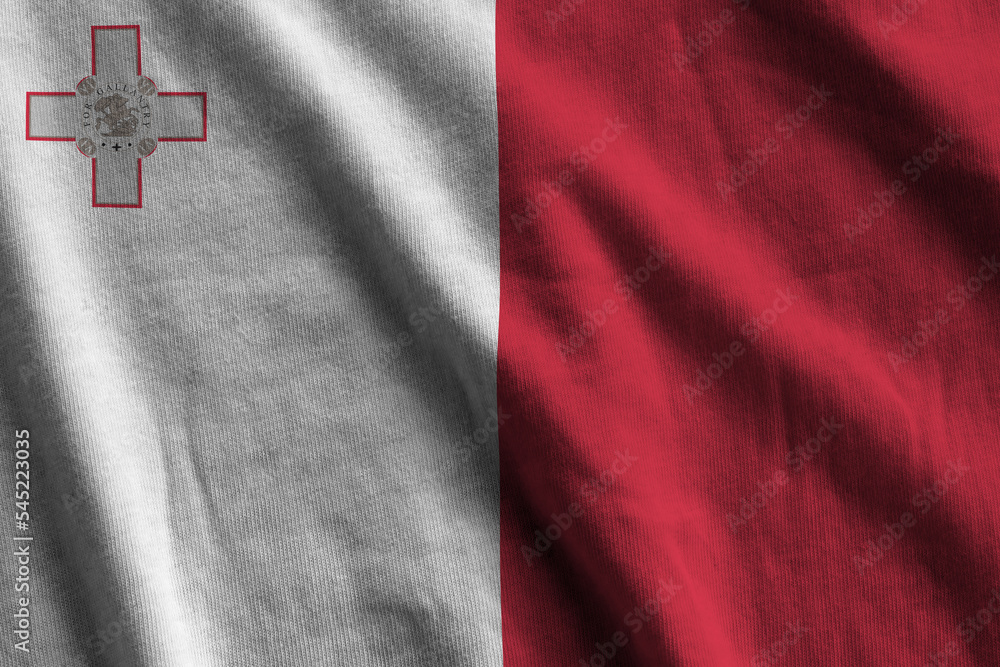 Malta flag with big folds waving close up under the studio light ...