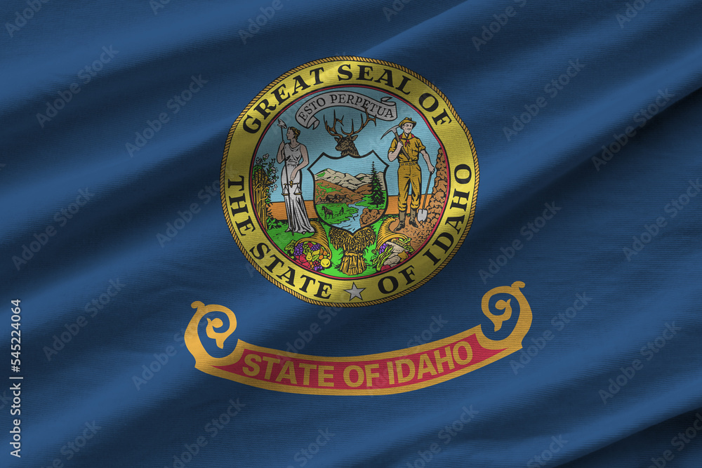 Idaho US state flag with big folds waving close up under the studio ...