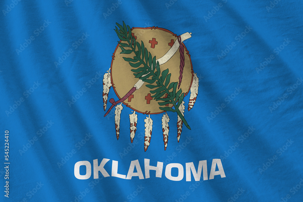 Oklahoma US state flag with big folds waving close up under the studio ...
