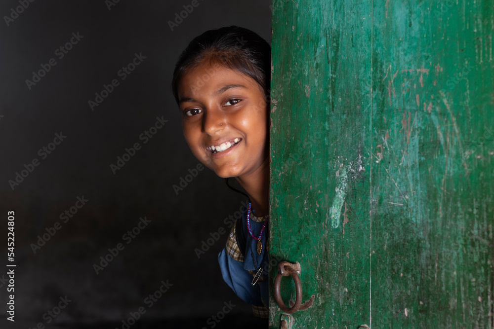 School girl peeping from a classroom Stock Photo | Adobe Stock